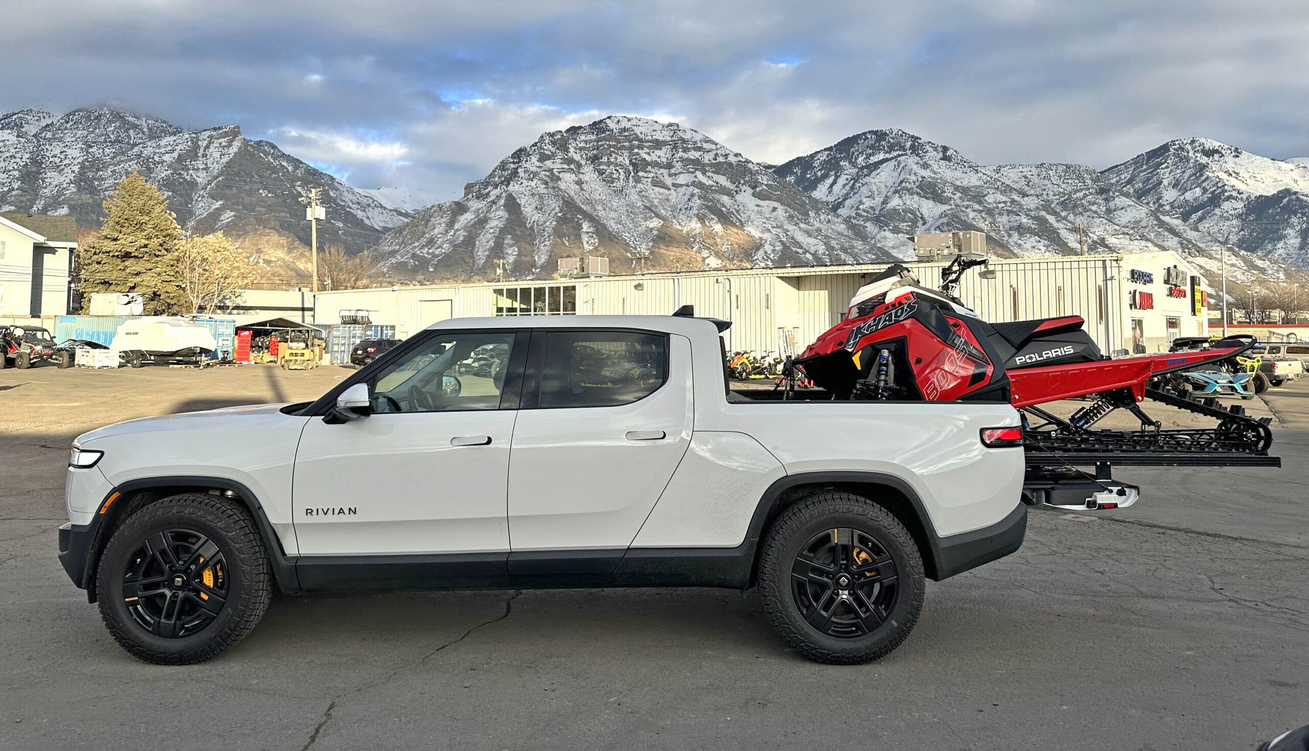 Snowmobile in R1T bed with deck / bed extender -- fits and performs ...